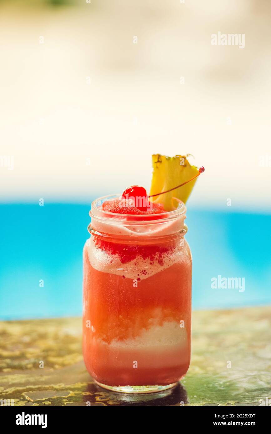 Colorful tropical cocktails on wooden bar. Mixology in pool holiday ...