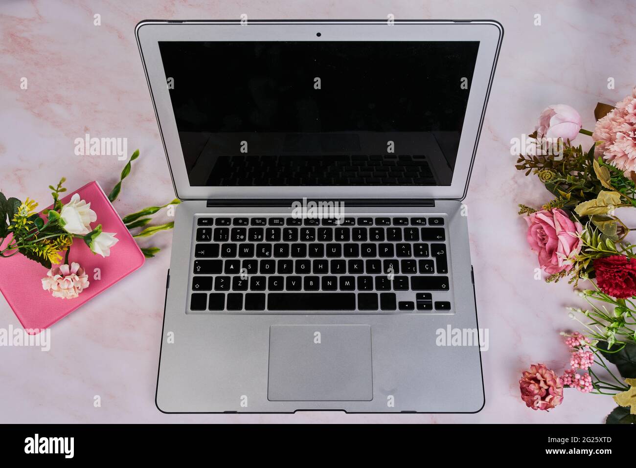 Laptop with a pink photo album, feminine concept Stock Photo - Alamy