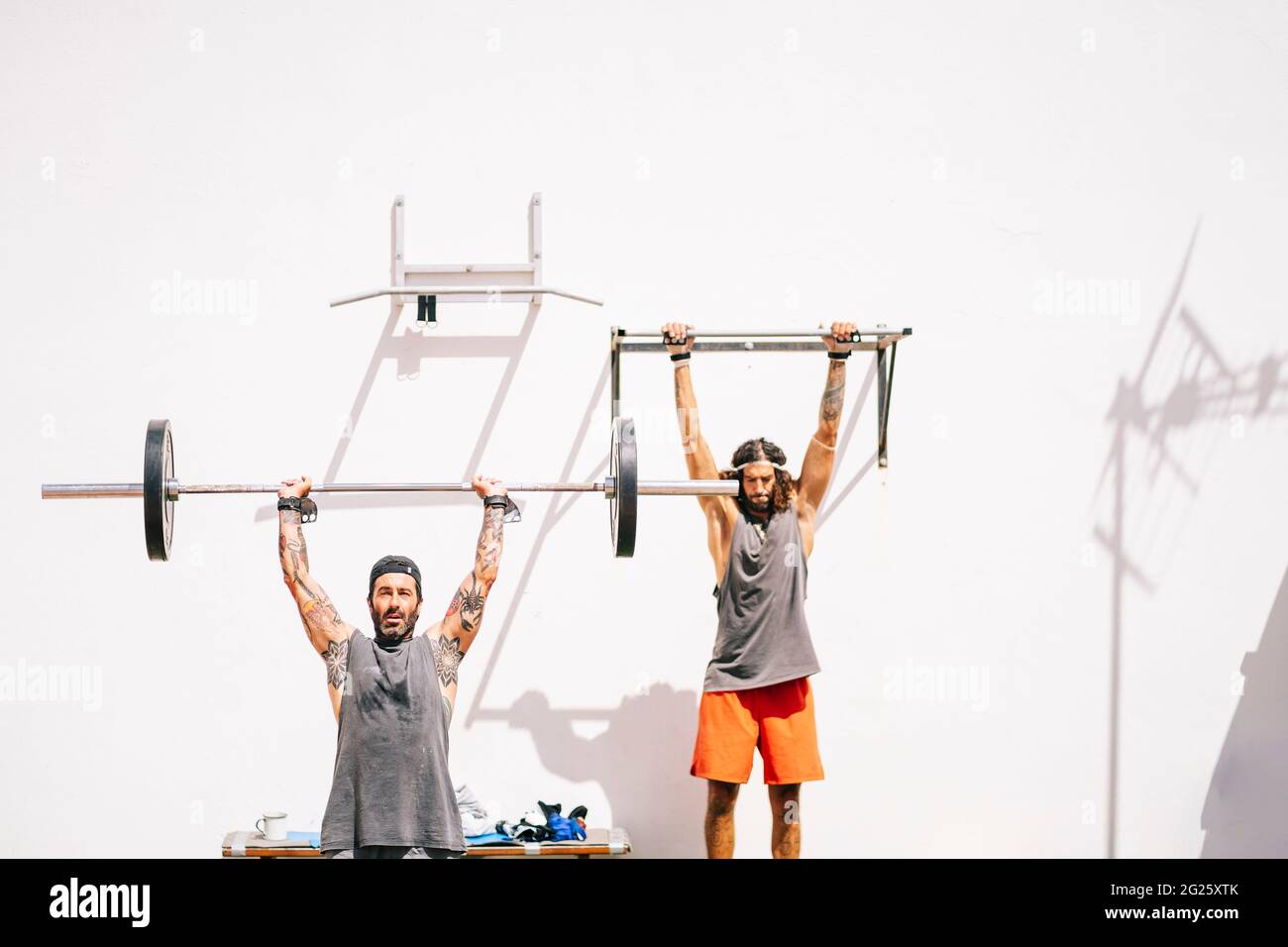 A group of sporty friends perform different exercise routines outdoors ...