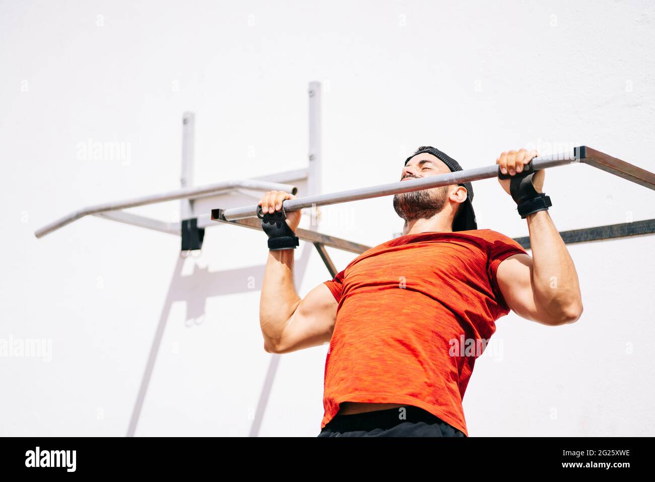 Strong man performing pull-up exercise outdoors Stock Photo - Alamy