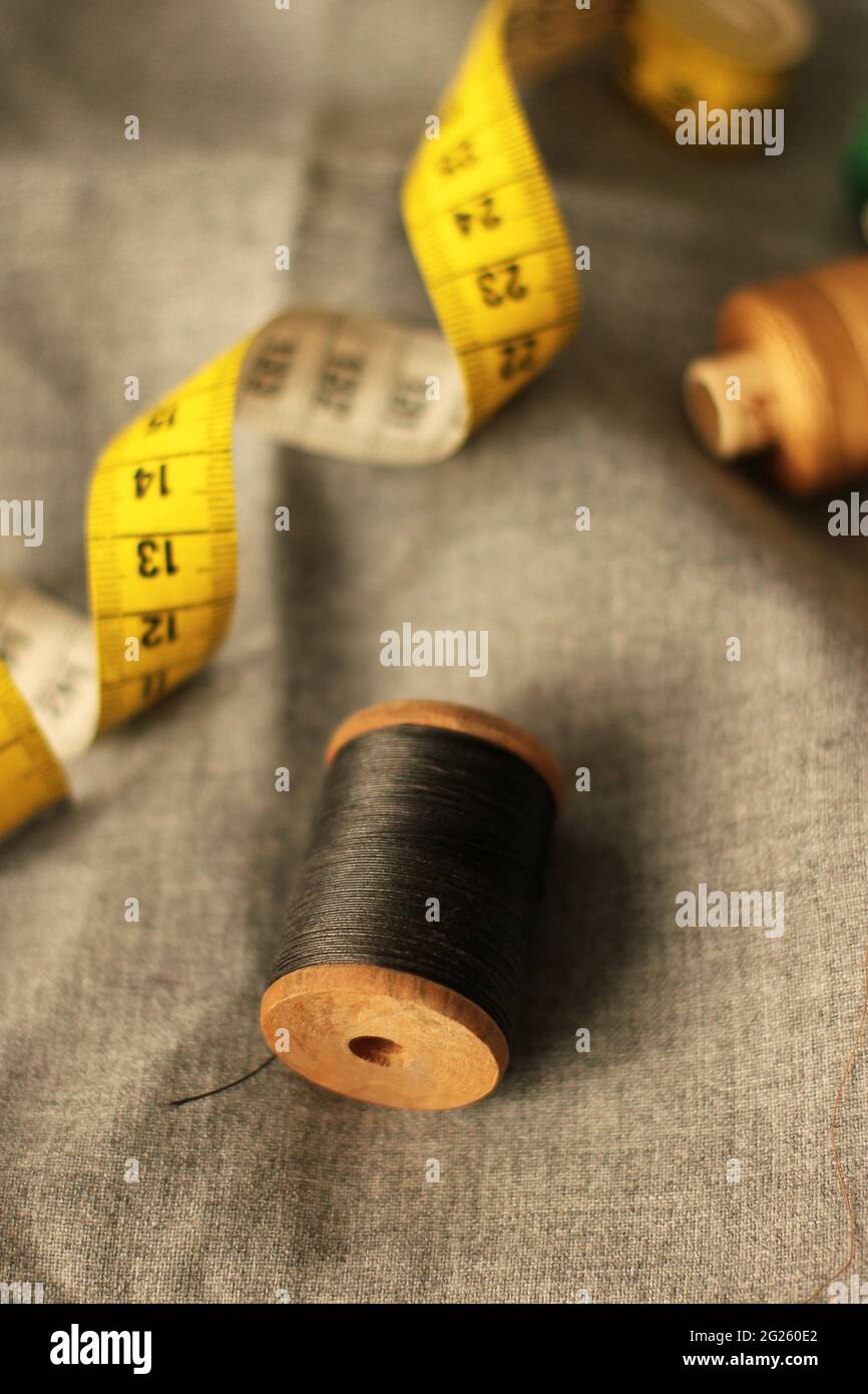 Sewing. Spools of thread on the fabric. Threads. Meter Stock Photo - Alamy