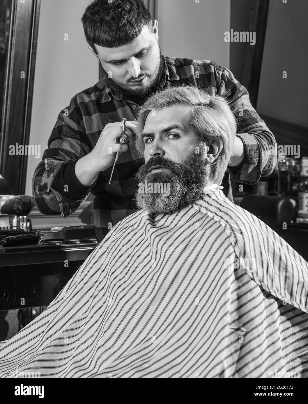 handsome male. barber tools in barbershop. handsome hairdresser cutting ...