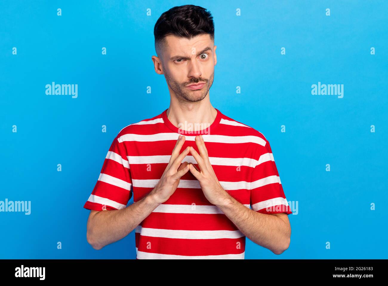 Photo of evil charming young man hold hands fingers together sneaky ...