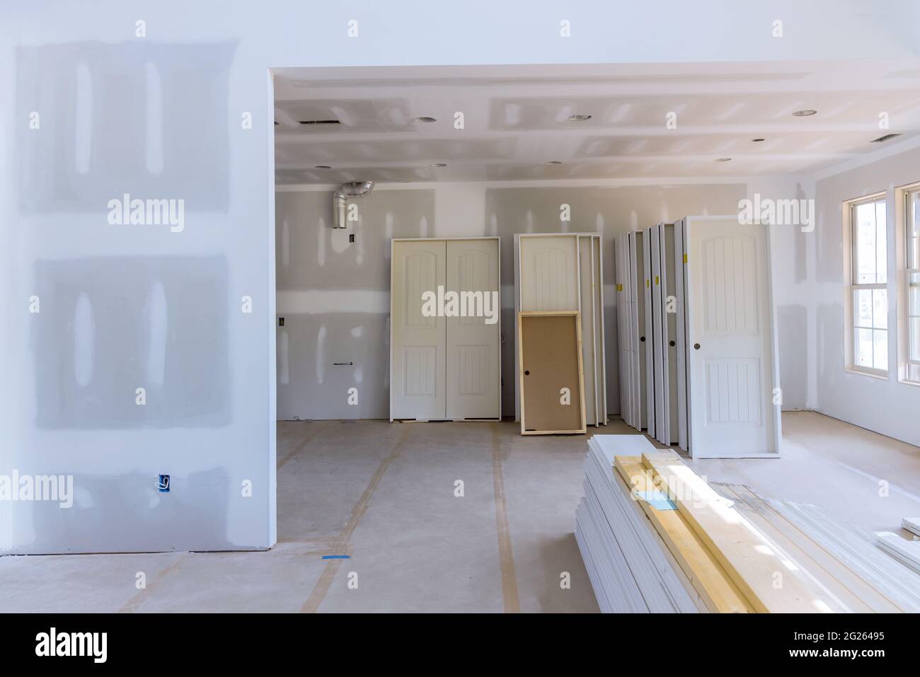 Interior wooden stacker door installation,apartment building, a wait ...