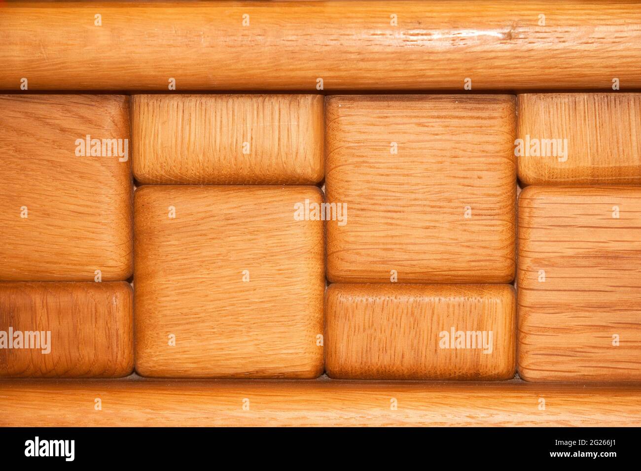 Various wooden blocks put together to form a mosaic in a frame made of ...