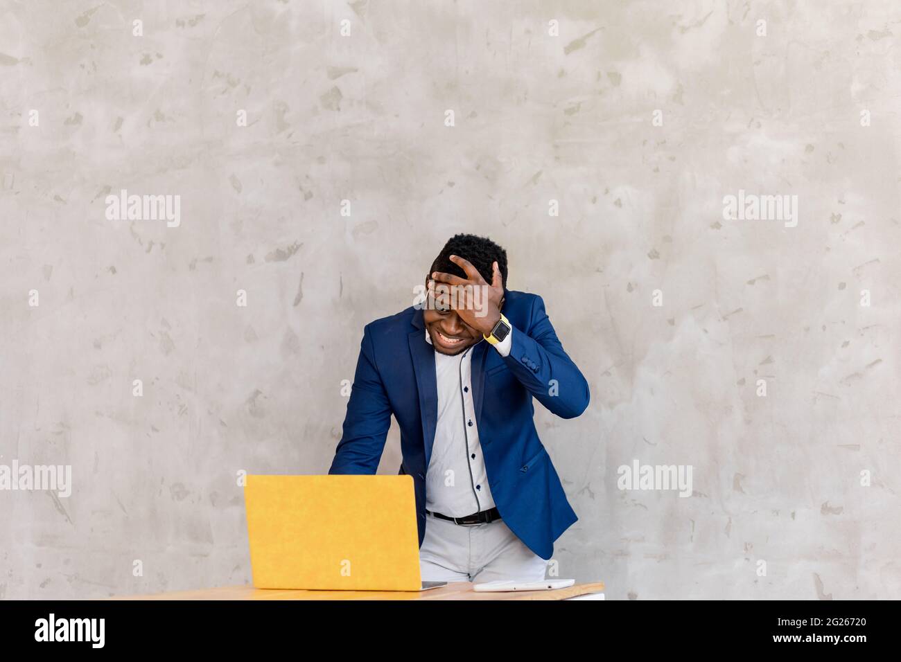 Stressed and tired African American man standing in office or at home ...