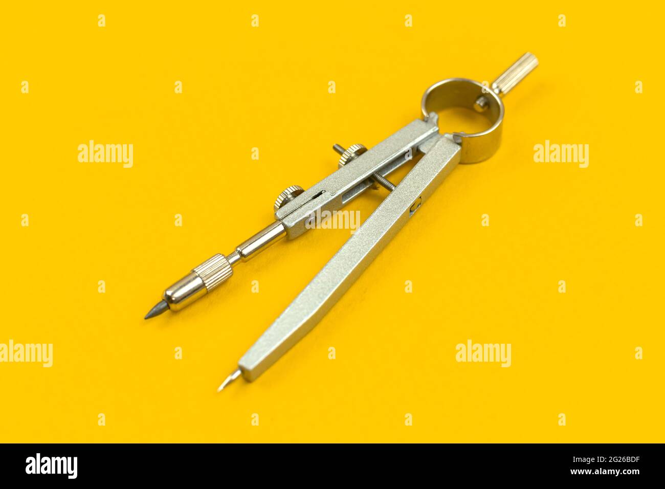 School drawing compass close-up on a office desk background, isolated ...