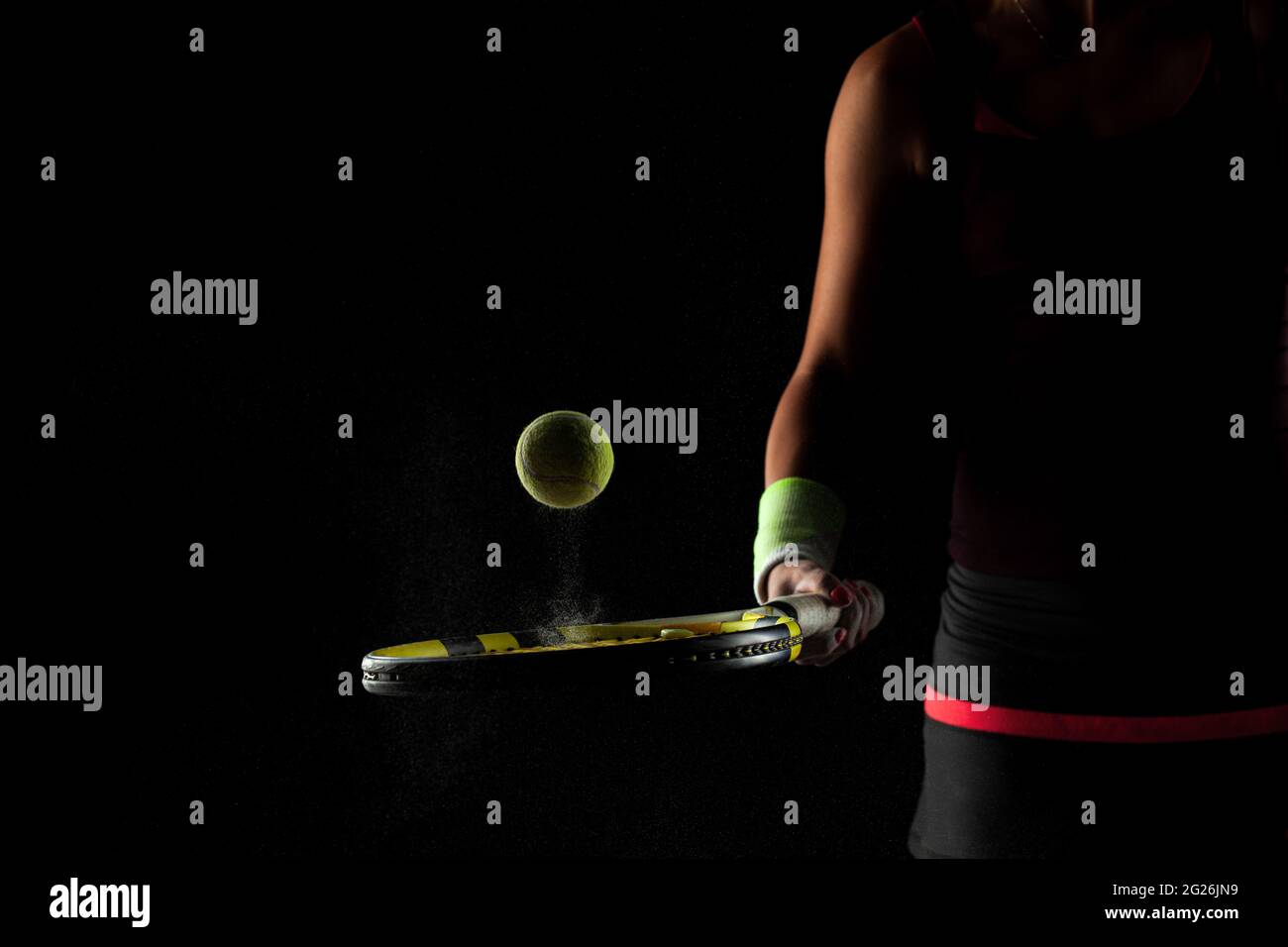 Tennis ball bouncing on racket. Dirt or magnesium dust dots visible in ...