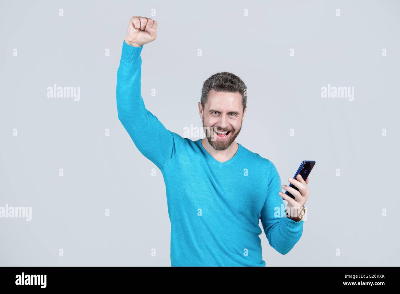 happy successful man with beard with smartphone, success Stock Photo ...