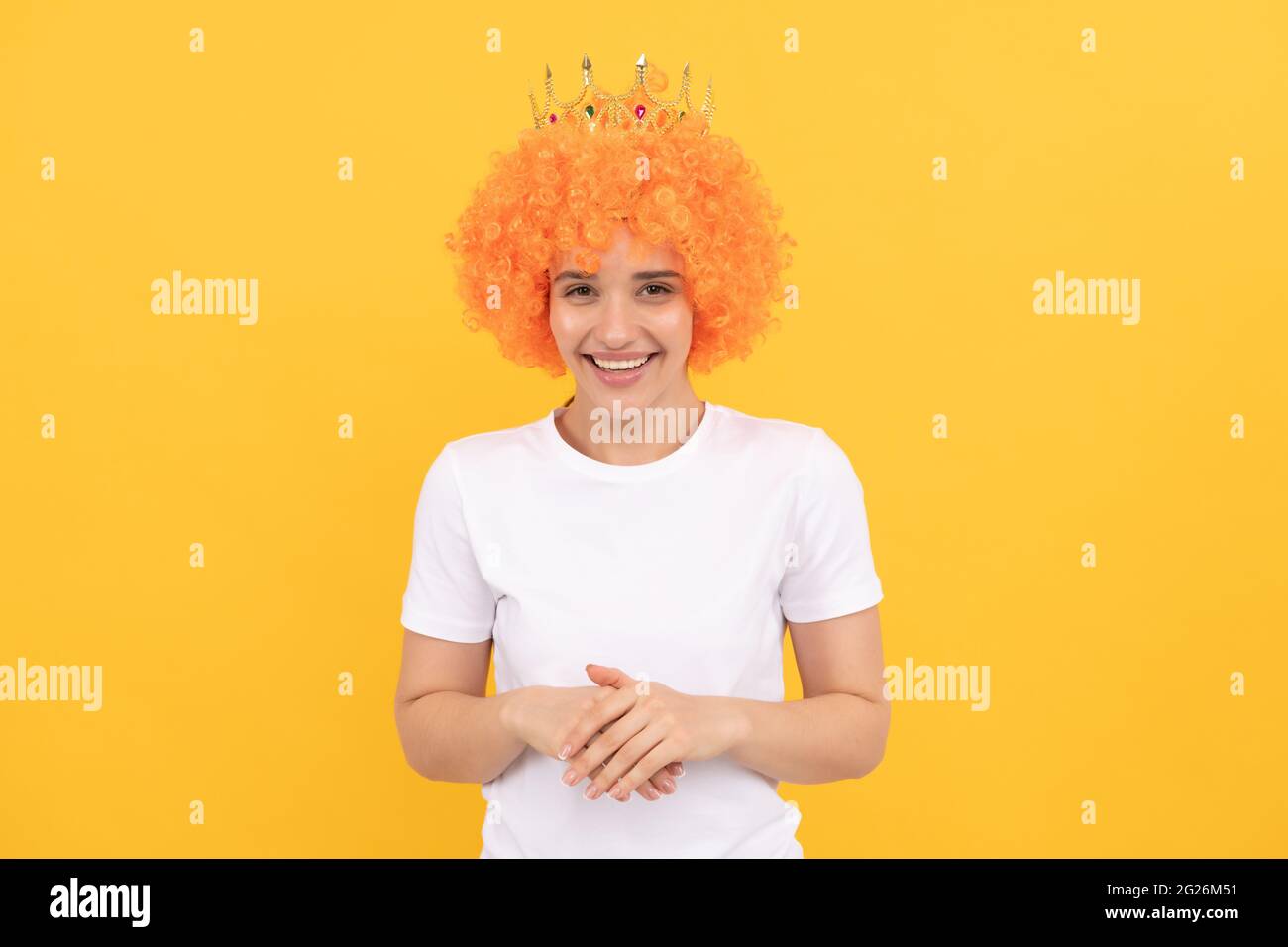 happy freaky selfish woman in curly clown wig and queen crown for party ...