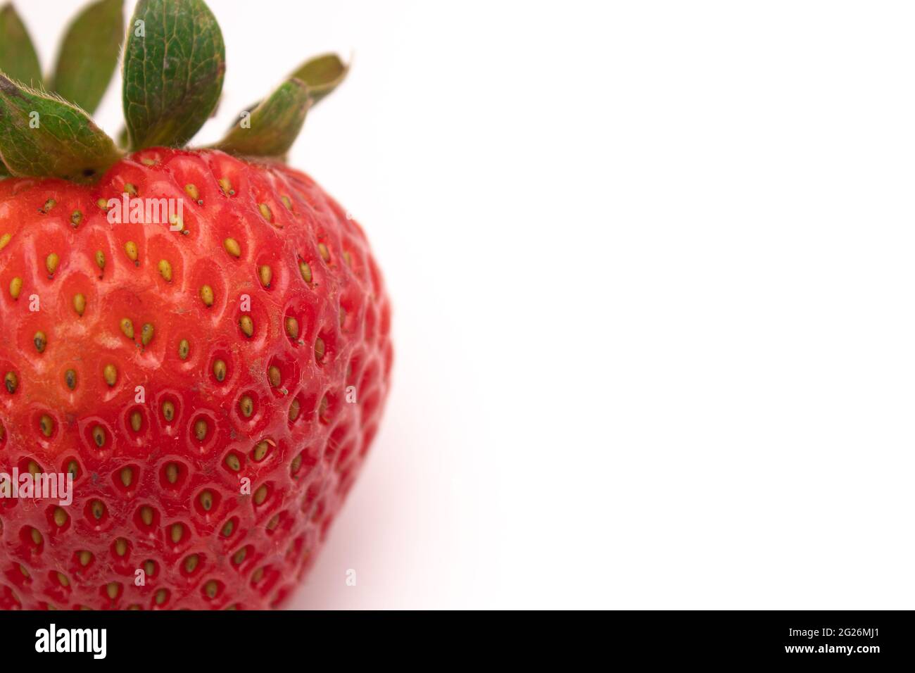 Closeup shot of a half of a strawberry on an isolated background Stock ...