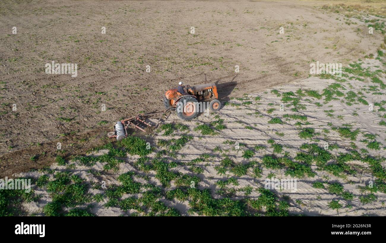 Aerial shoof an old tractor plowing Stock Photo - Alamy
