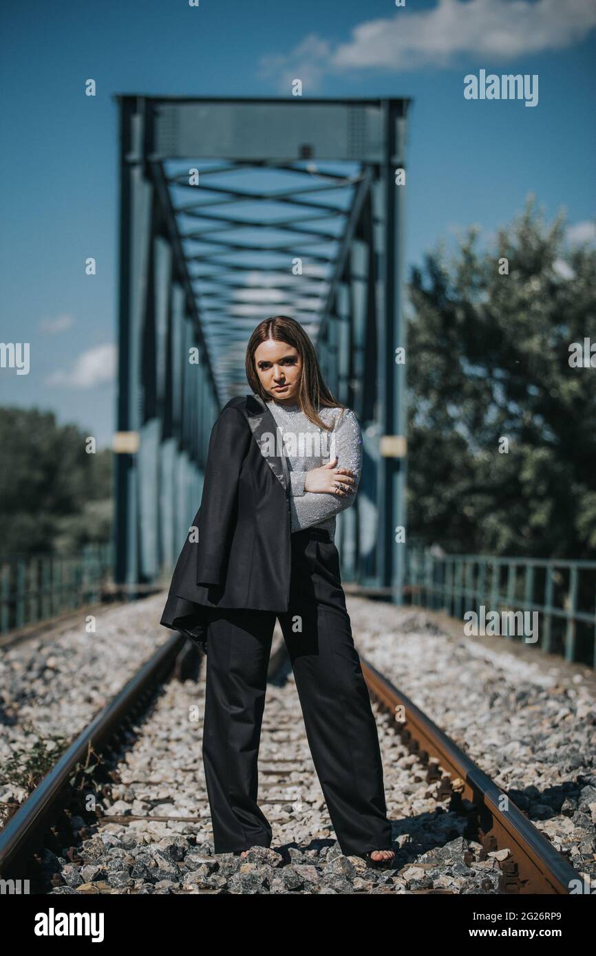 Vertical shot of a Caucasian female posing on train rails Stock Photo ...