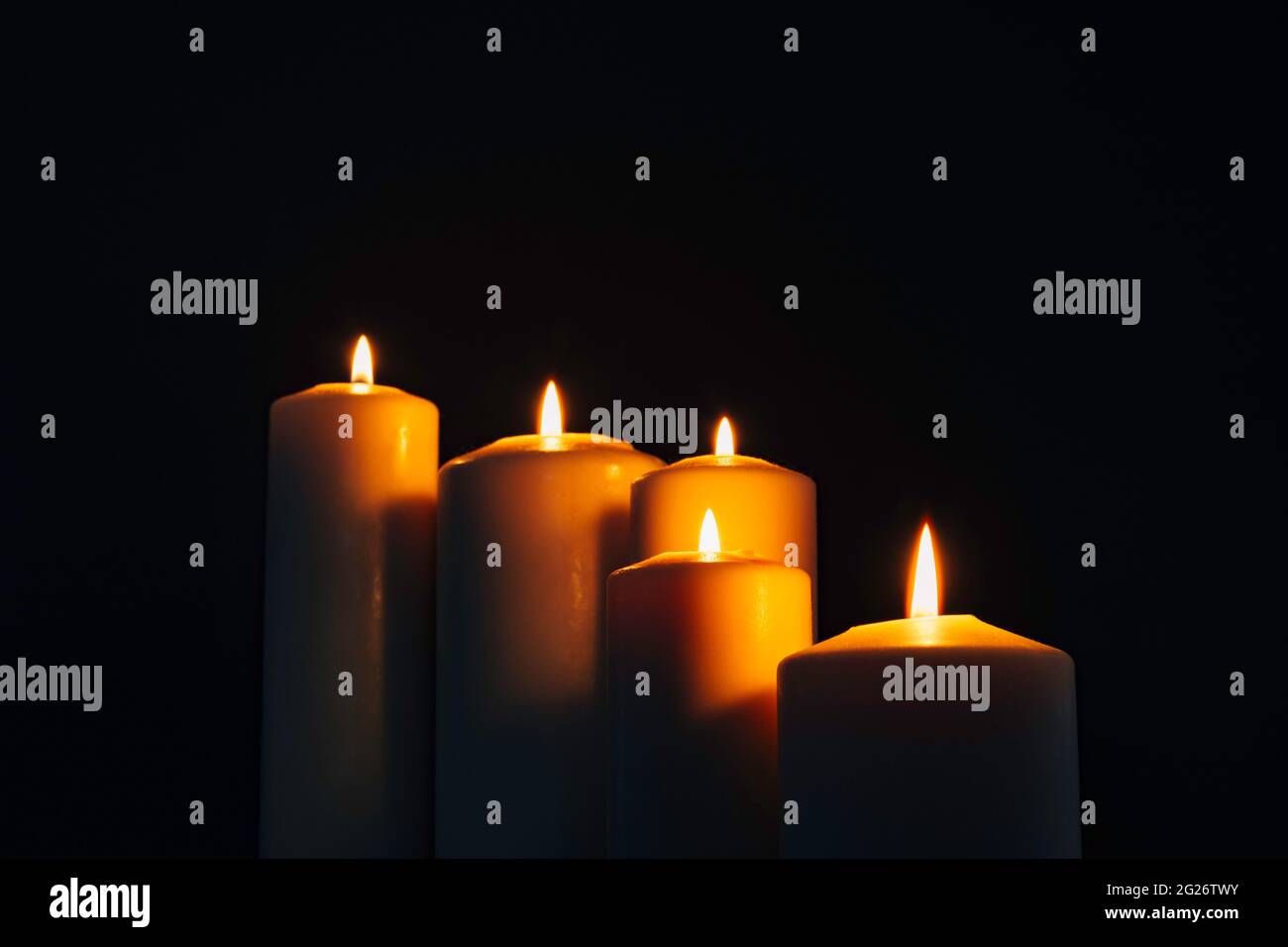Grouping of burning candles Stock Photo - Alamy