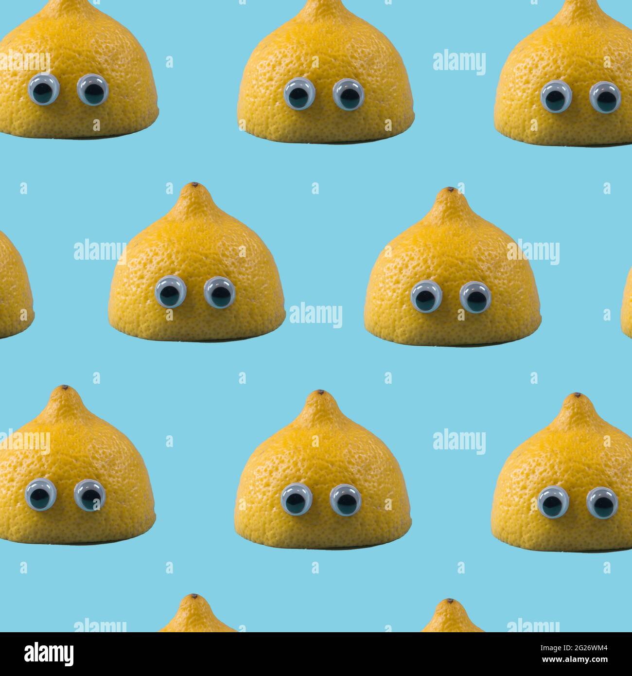 Lemon half with toy eyes multiplied on trendy soft blue background ...
