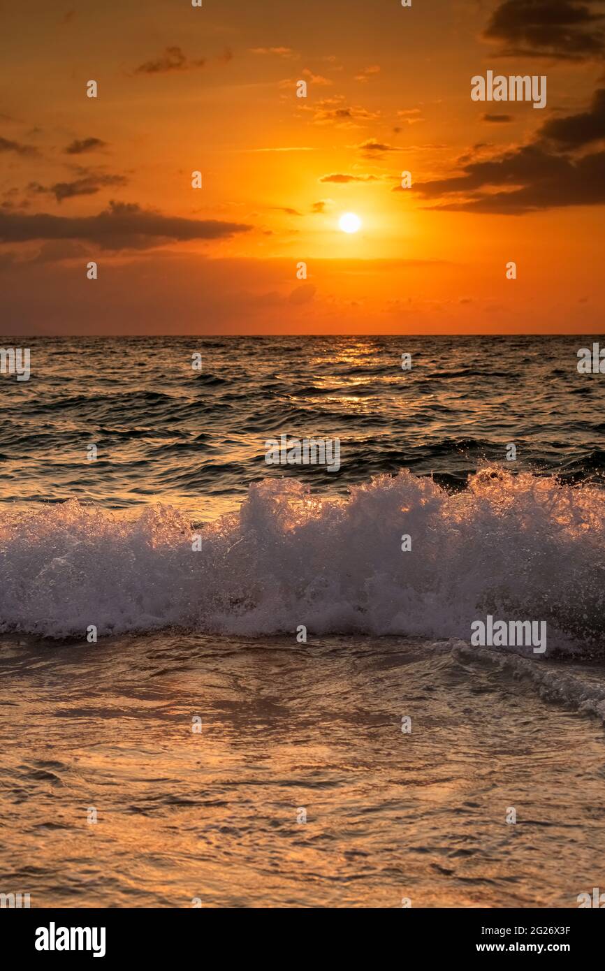 A Wave Is Breaking In A Colorful Ocean Sunset Landscape As A Gentle ...