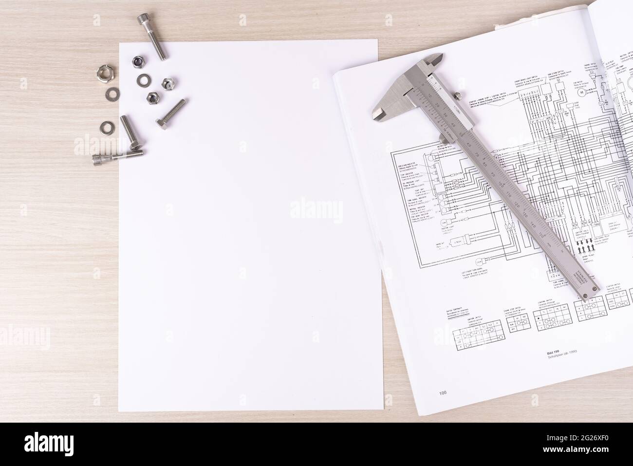Top view of the various steel nuts and bolts and vernier caliper on the ...