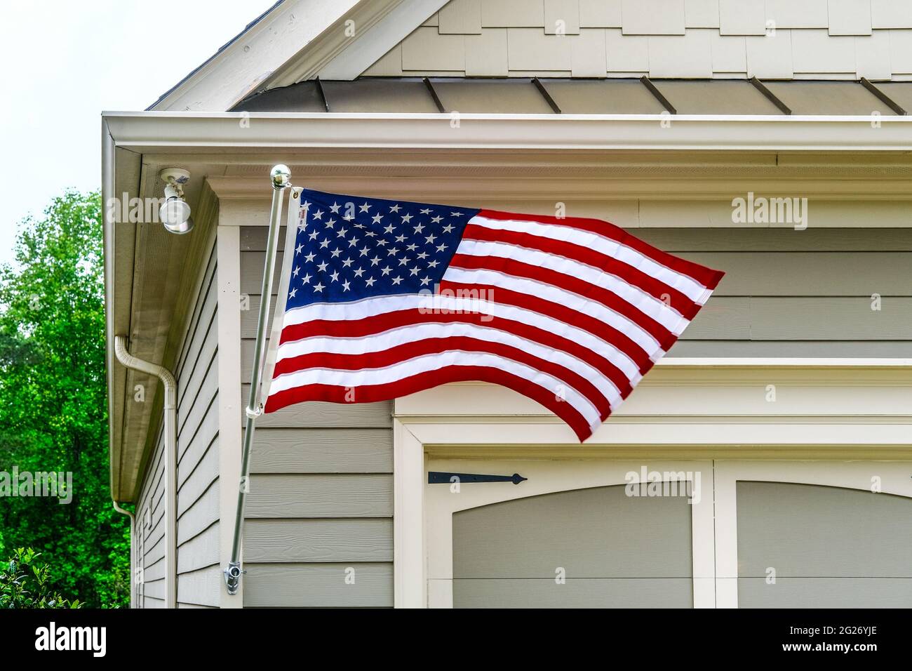 American Flag on Siding House by Garage Stock Photo - Alamy