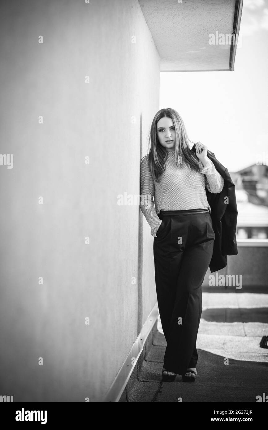 Grayscale portrait of an adult confident woman wearing a suit and ...