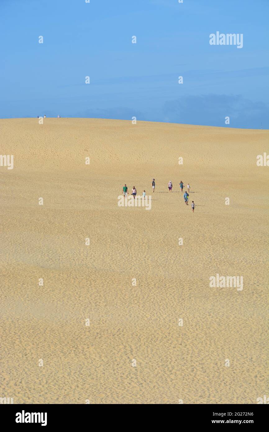 A family hikes the dunes at Jockeys Ridge State Park on the Outer Banks ...