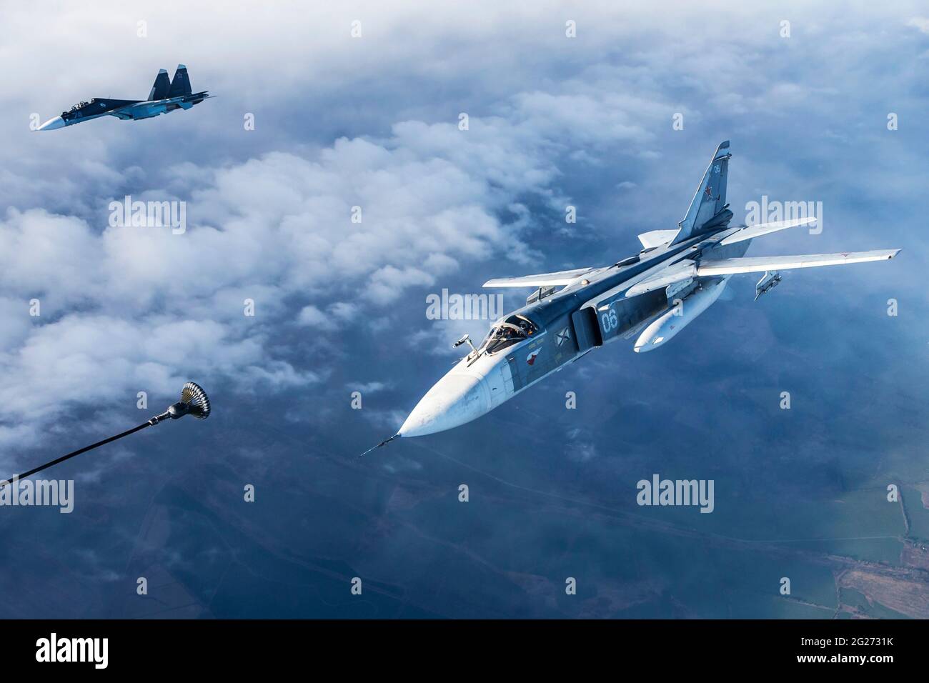 Su-24M frontline bomber plane and a Su-30SM jetfighter of the Russian ...