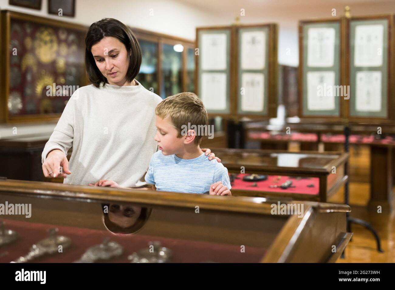 Woman and boy exploring artworks in museum Stock Photo - Alamy