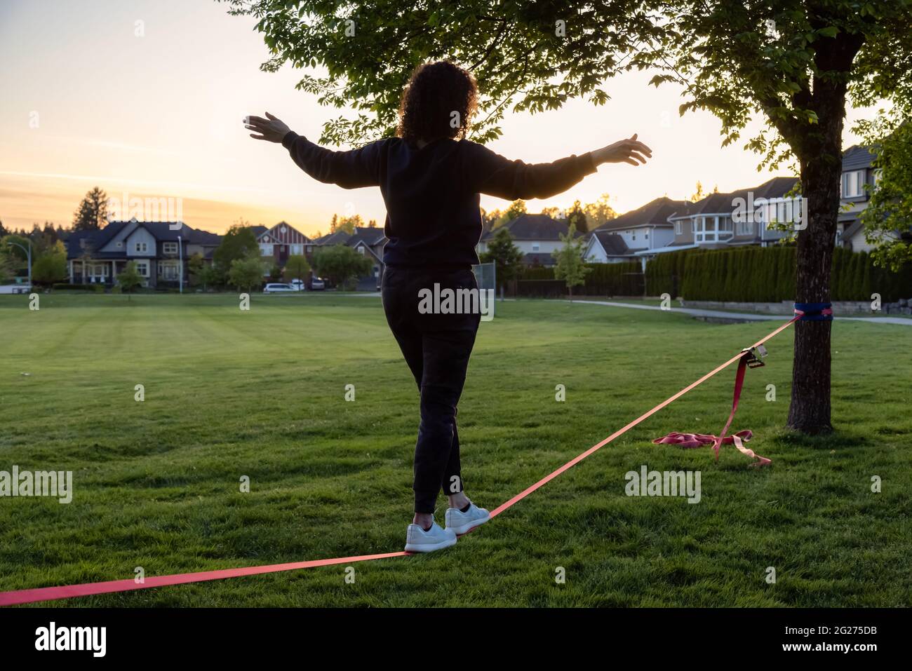 Adventurous White Caucasian Adult Woman walking on a Slackline Stock ...