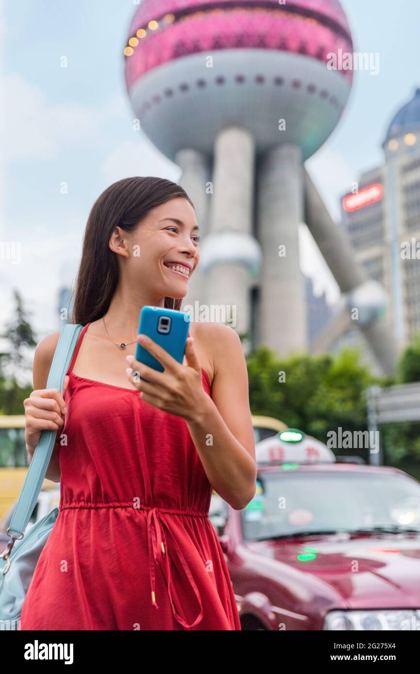 Asian lady using mobile pay phone app for taxi cab Stock Photo - Alamy