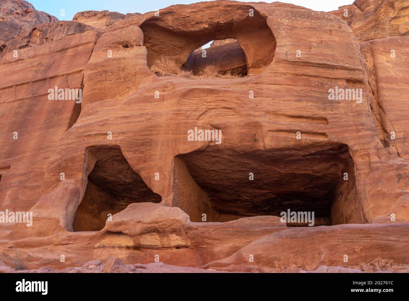 Carved niches in multicolored red-rose sandstone with signs of ...