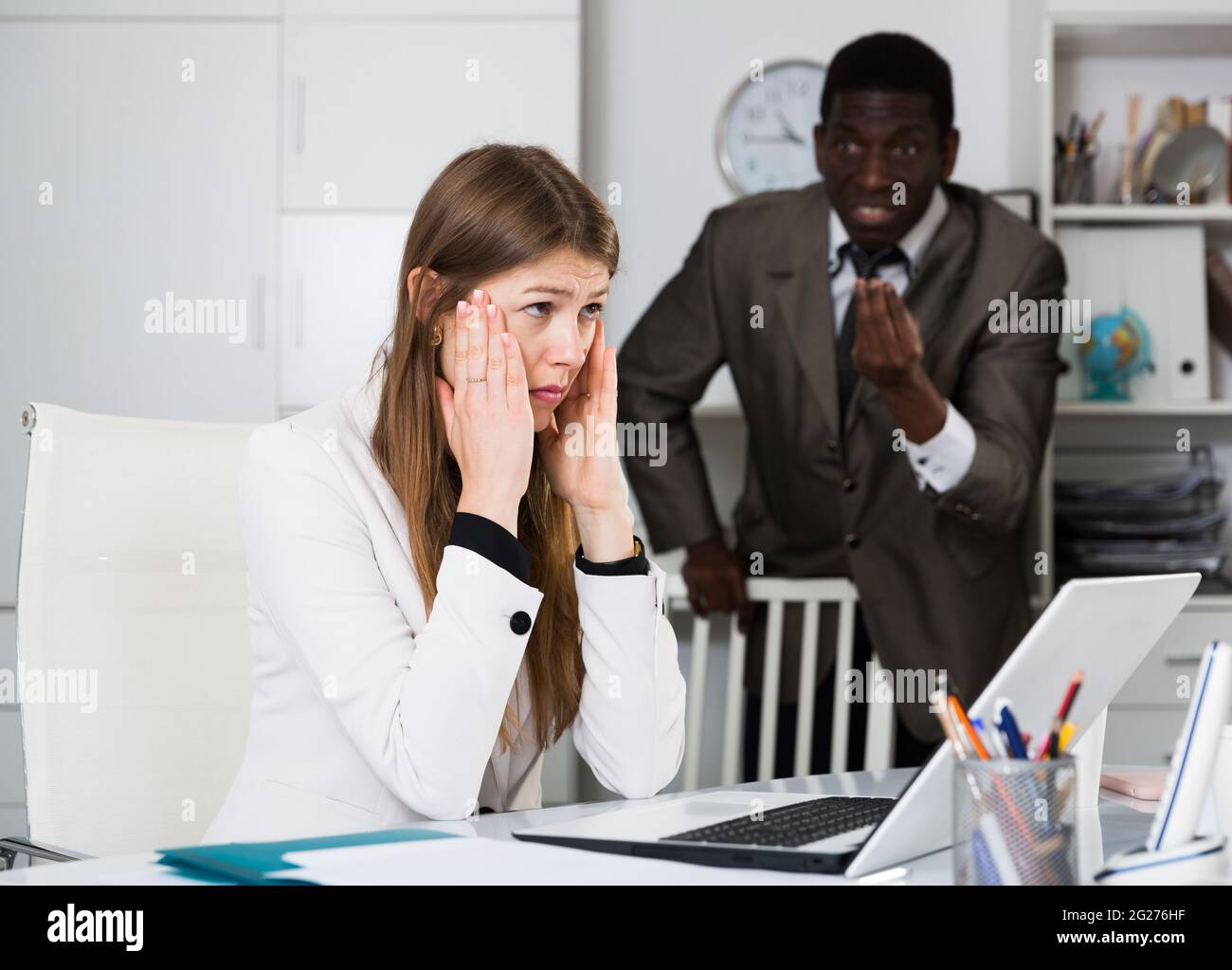 Upset woman with angry boss Stock Photo - Alamy