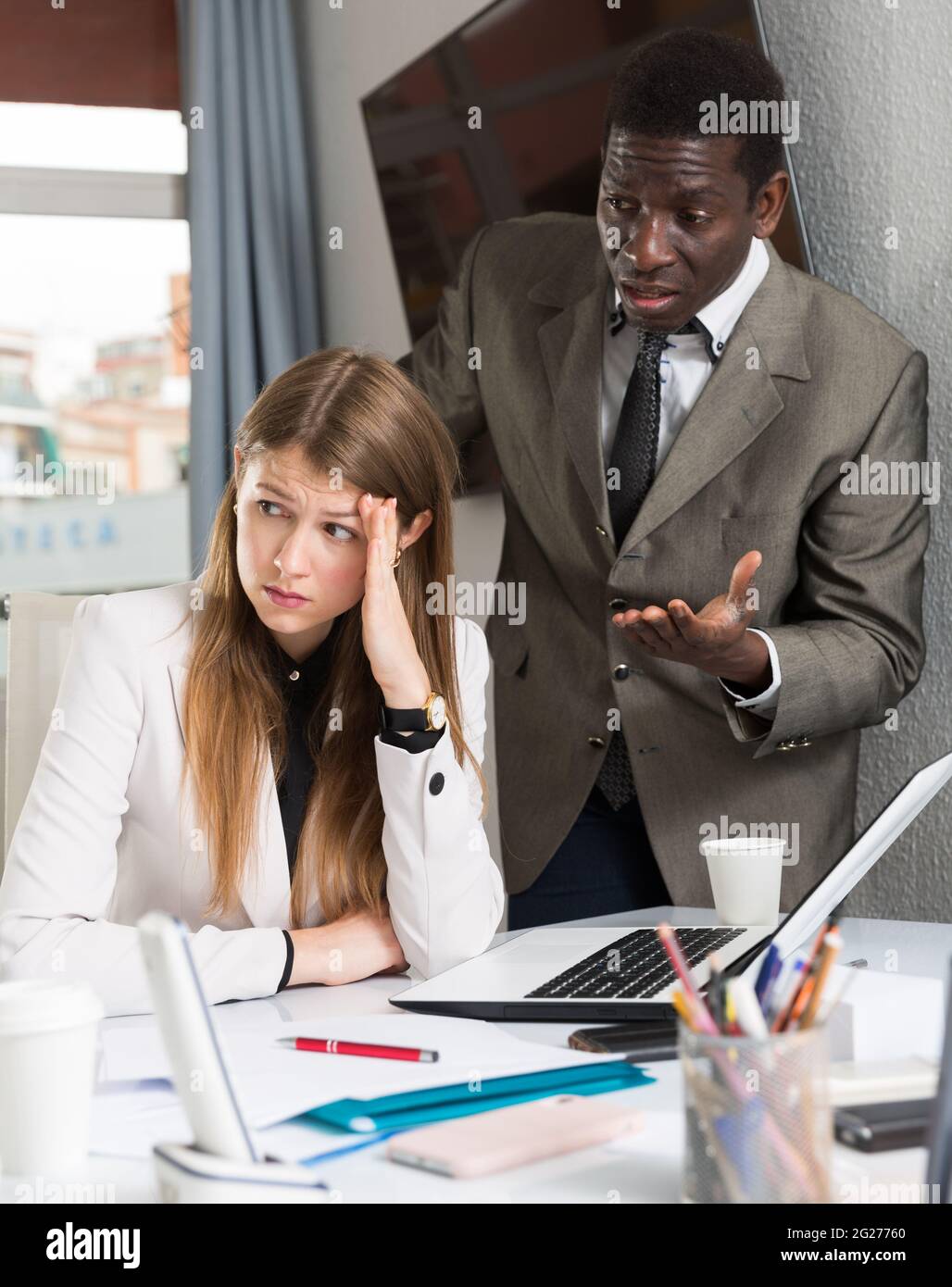 Upset woman with angry boss Stock Photo - Alamy