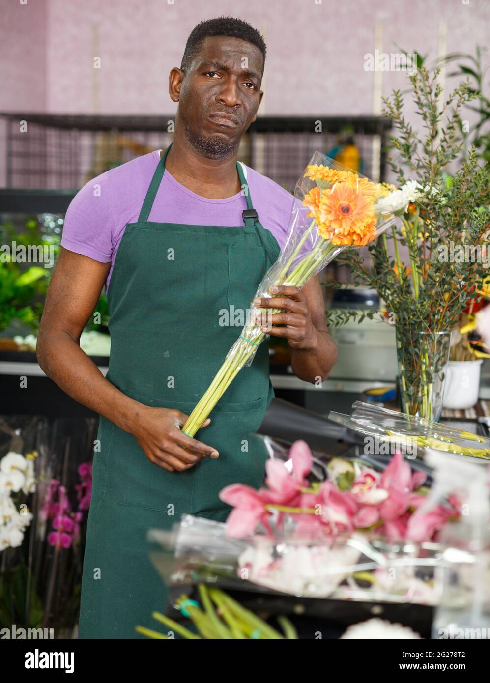Dissatisfied owner of flower shop Stock Photo - Alamy