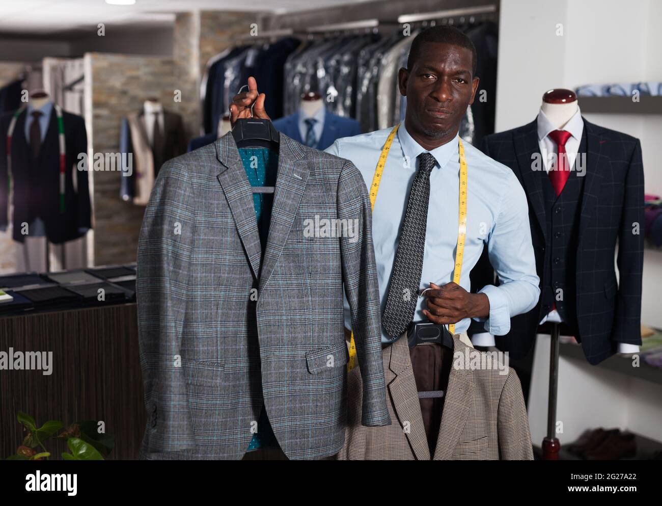 Portrait of afro-american man buyer choosing business style jacket in ...