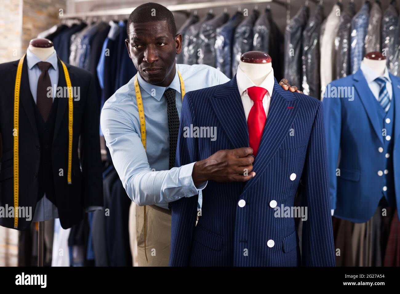Seller is demonstrating jacket and tie in store Stock Photo - Alamy