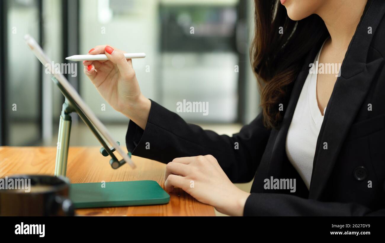 Side view of businesswoman hand with stylus pen working on digital ...