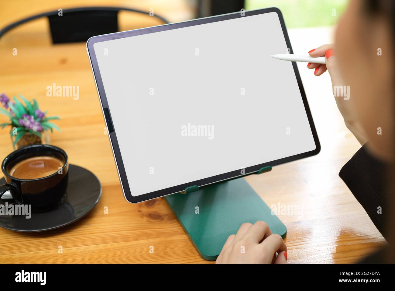 Close up view of female working on digital tablet with mock-up screen ...