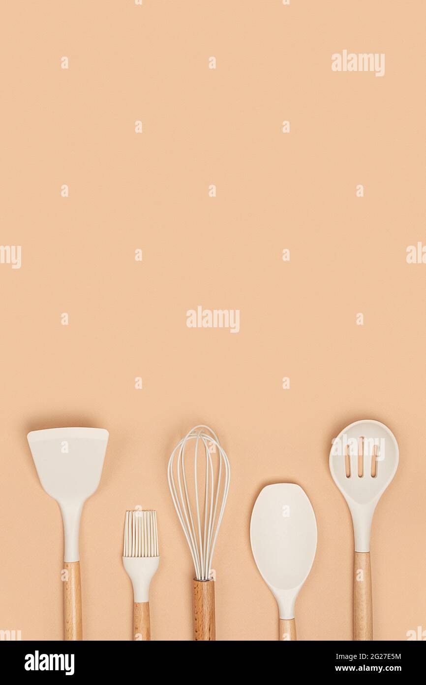 Cooking utensil set. Silicone kitchen tools with wooden handle on beige ...
