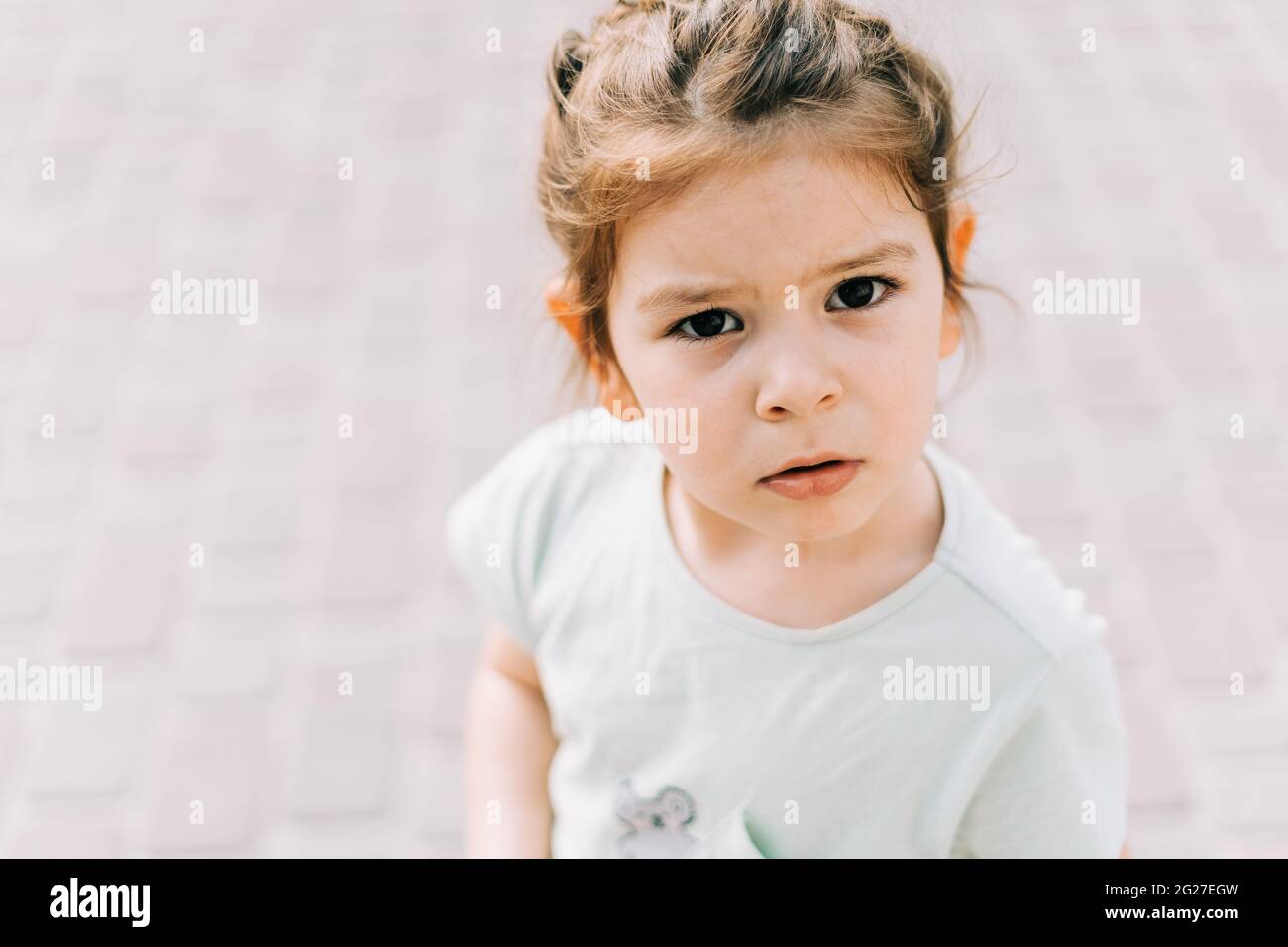 Toddler girl portrait outdoors. Lifestyle child face with big brown ...