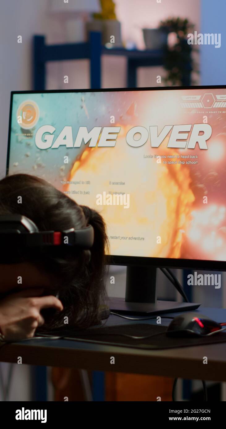 Pro woman gamer losing space shooter video game competition on ...