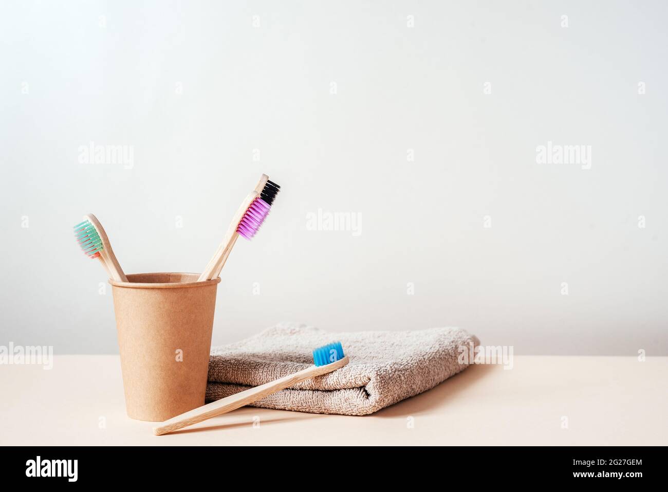 Eco friendly bamboo toothbrushes of different colors in paper cup, zero ...