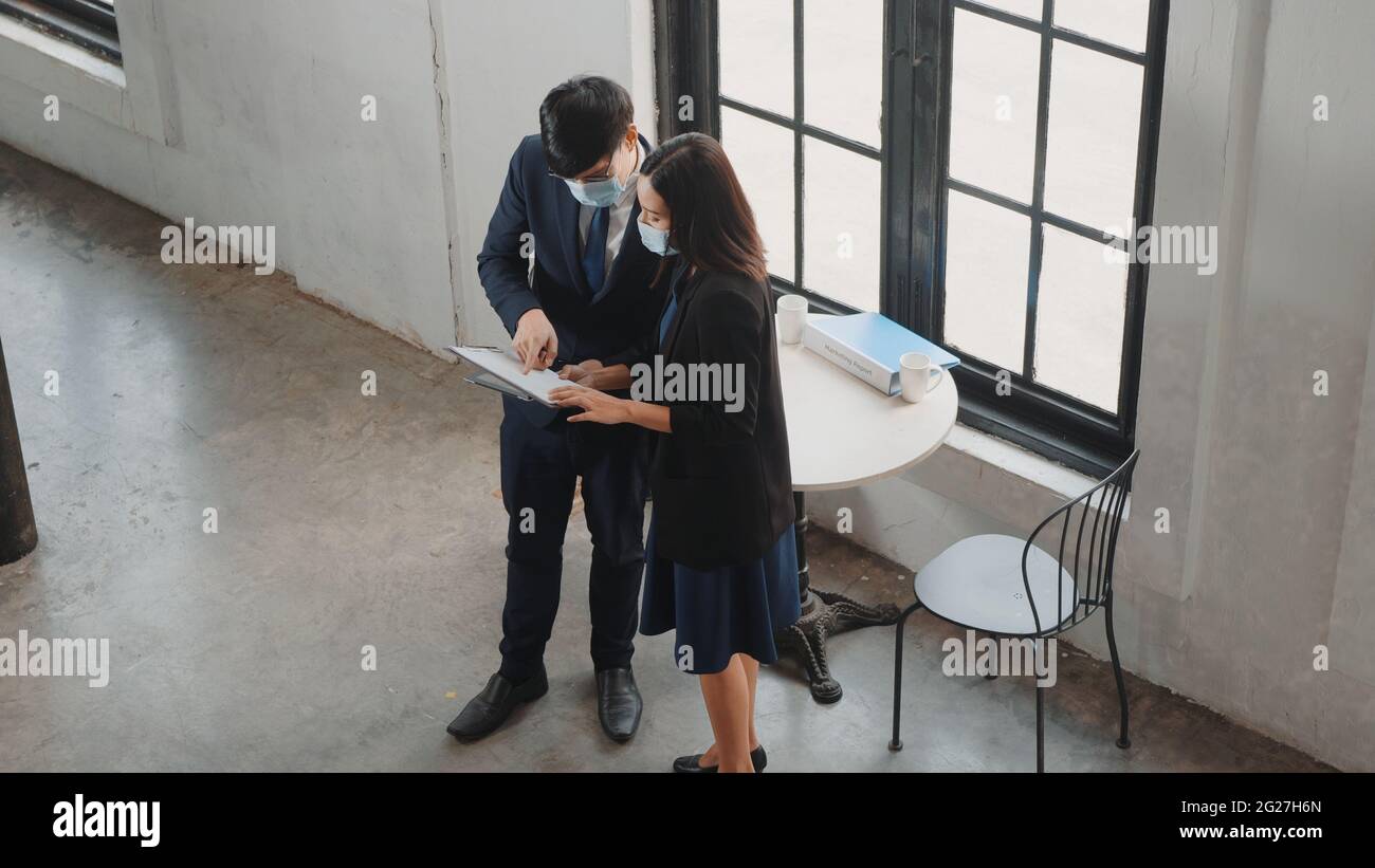 Top view two Asian businessman and woman wearing protective face mask ...
