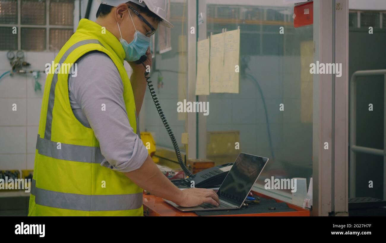 Asian factory worker man offering phone receiver as business ...