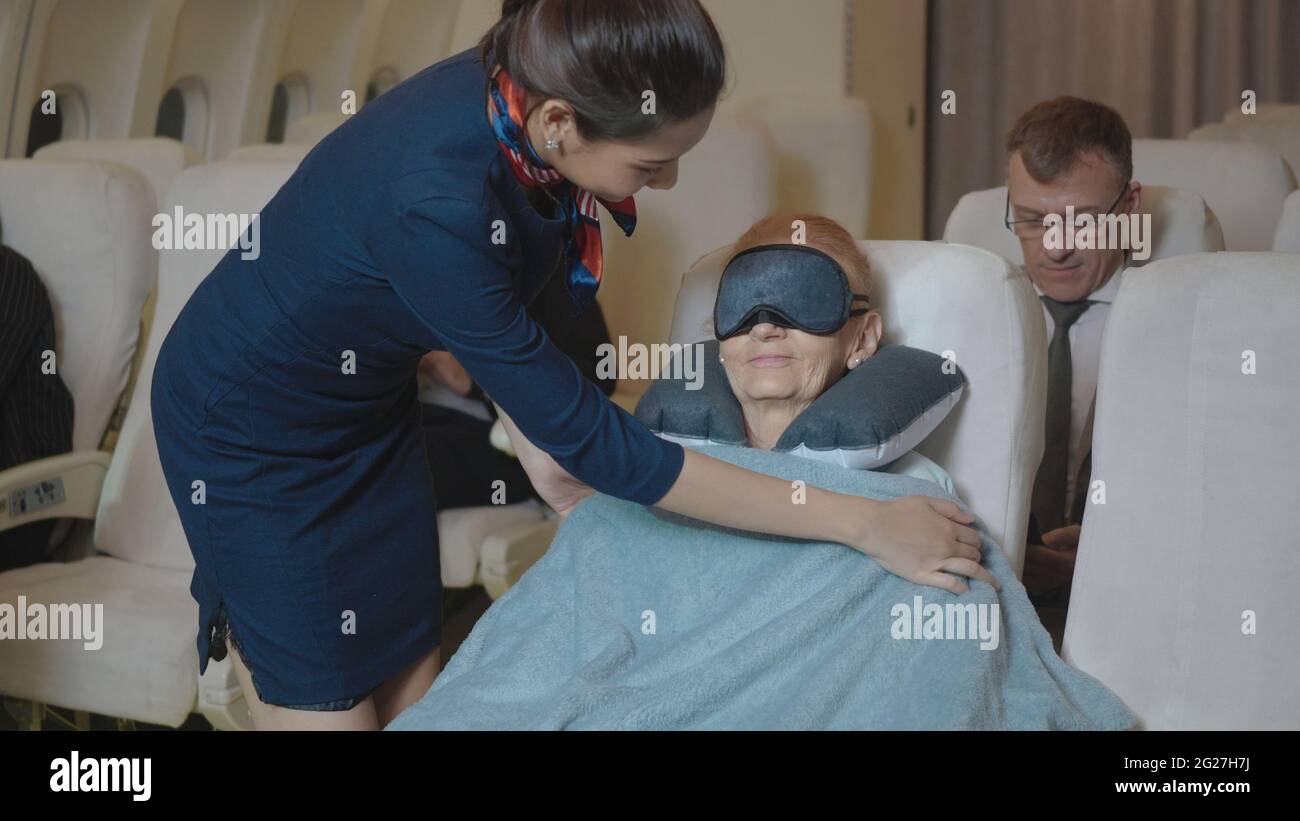 Happy stewardess taking care of passenger adult businesswoman, Air ...
