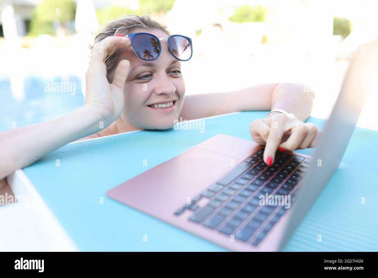 Woman laptop pool hi-res stock photography and images - Alamy