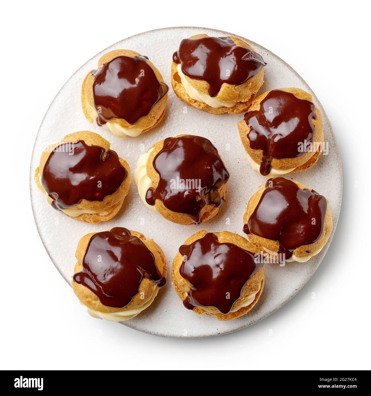 plate of freshly baked cream puffs covered with melted chocolate ...