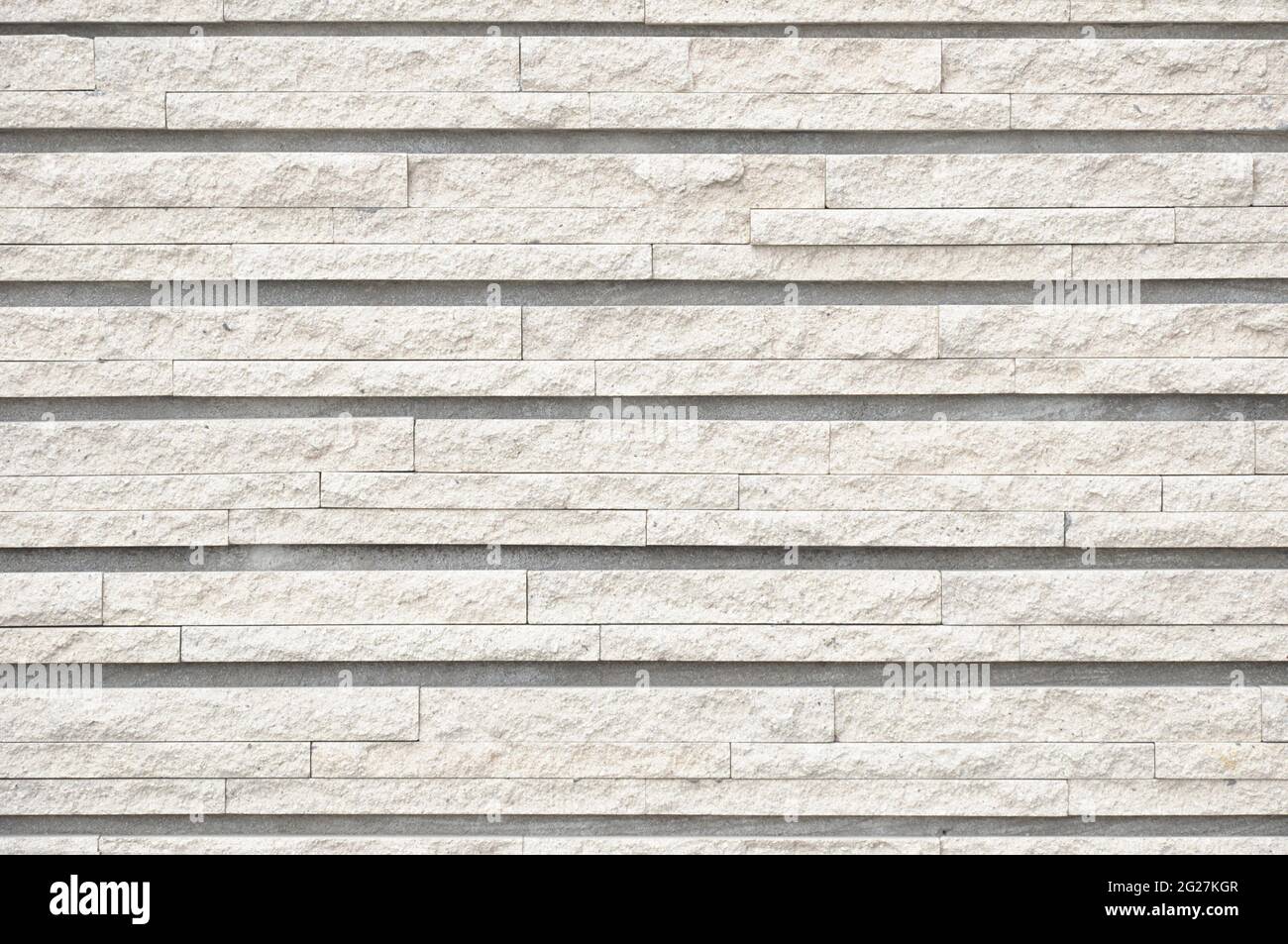 Grooved decorative stone wall texture as background Stock Photo - Alamy