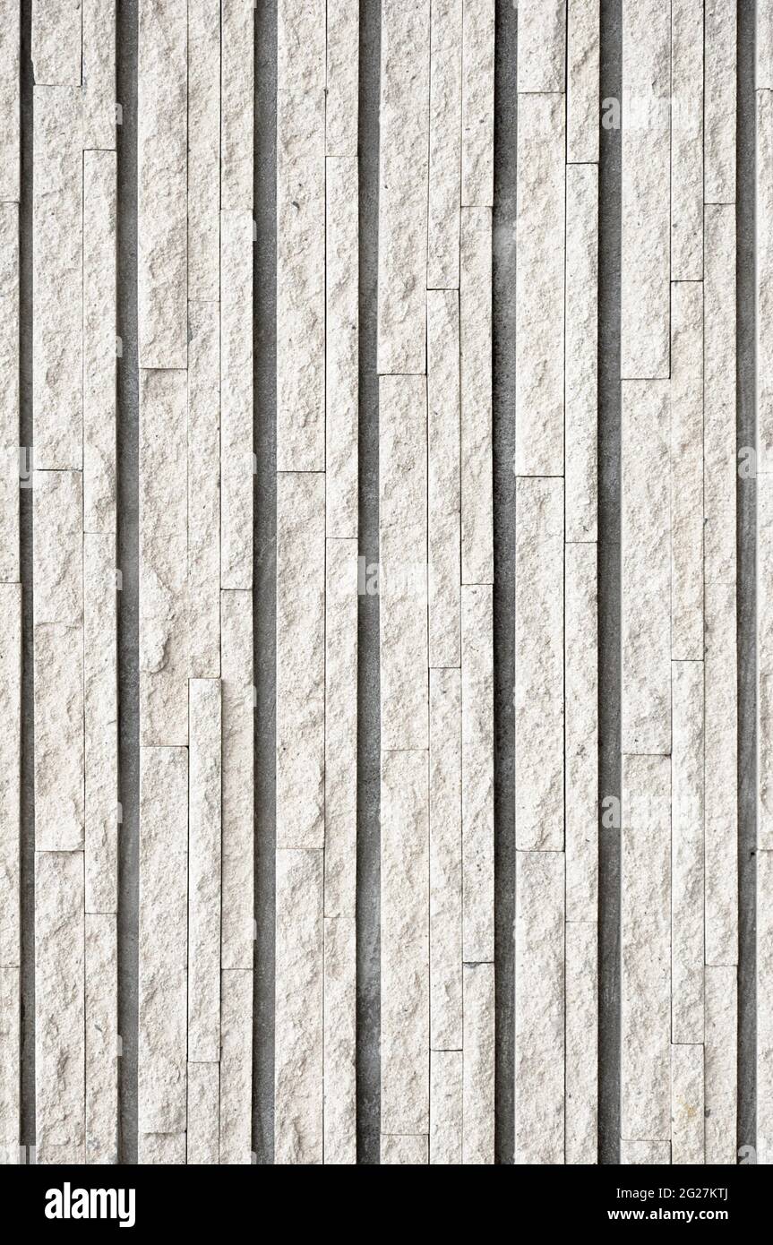 Grooved decorative stone wall texture as background Stock Photo - Alamy