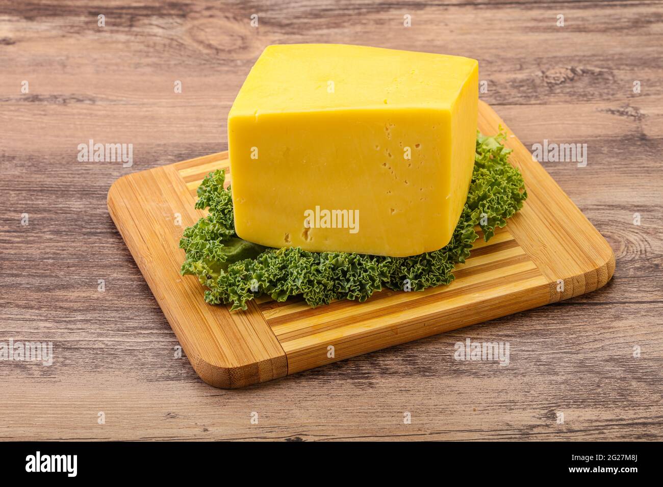 Yellow tilsiter cheese dairy product brick Stock Photo - Alamy
