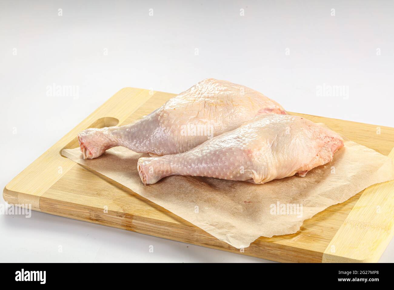 Raw chicken leg over background isolated Stock Photo - Alamy