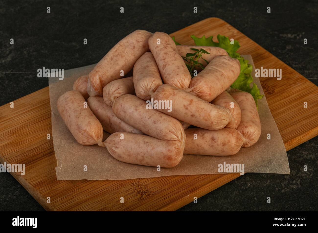 Raw natural chicken baby sausages for roast Stock Photo - Alamy